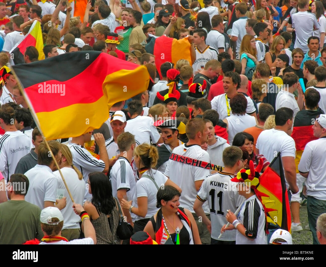 German football fans with German flag and different fan articles in ...