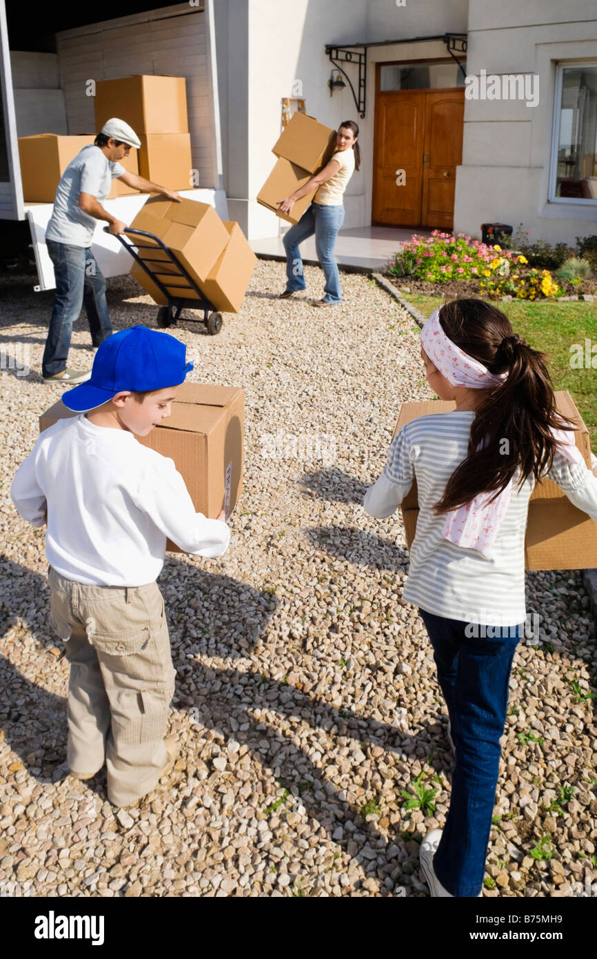 Family carrying cardboard boxes Stock Photo - Alamy