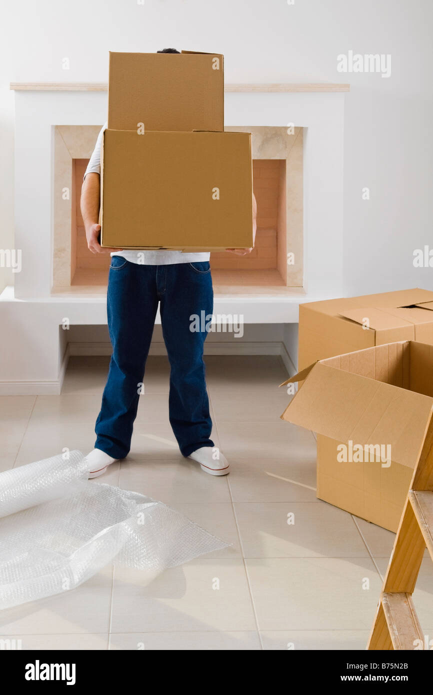 Person carrying cardboard boxes Stock Photo - Alamy