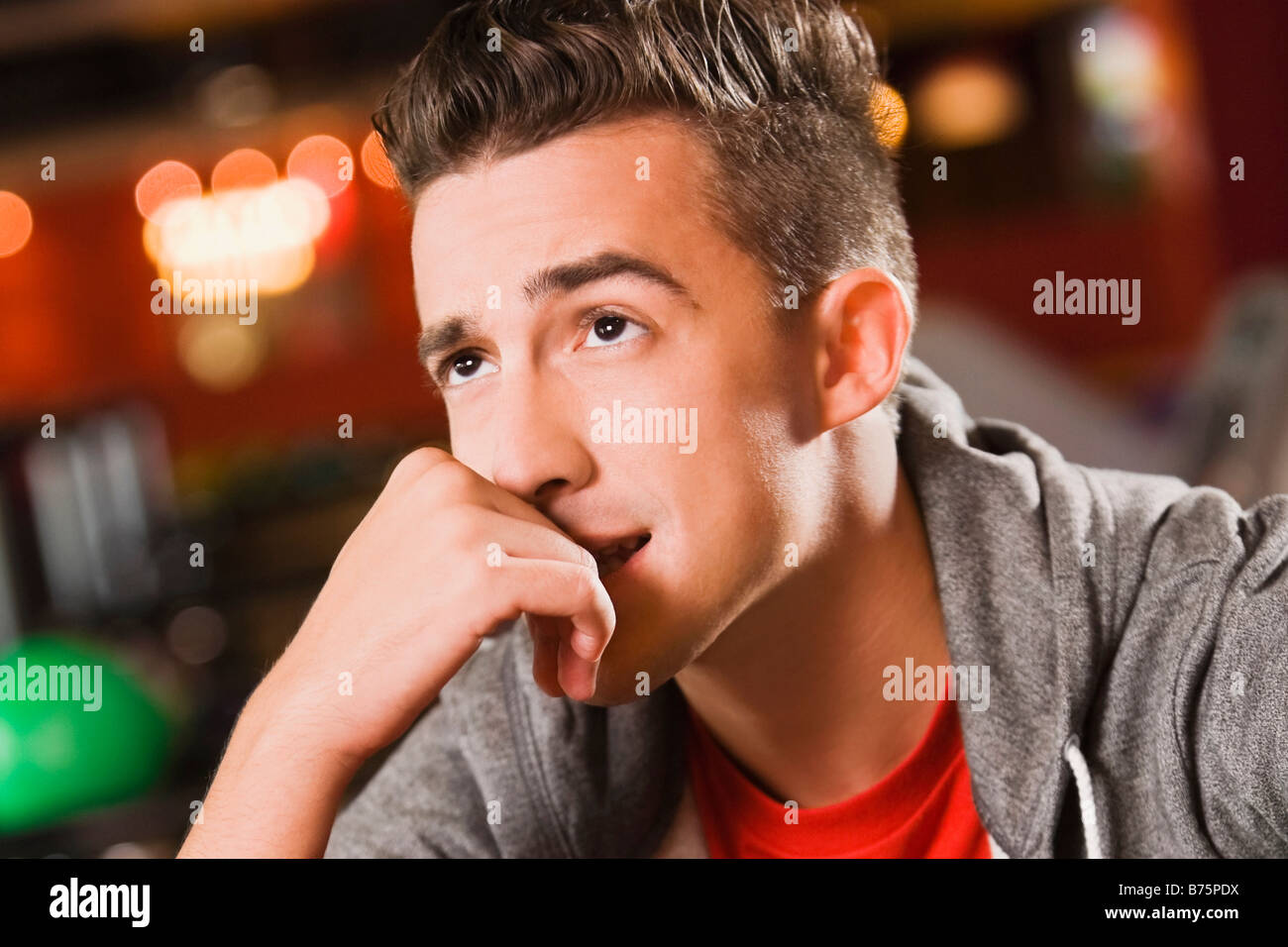 Close-up of a young man thinking Stock Photo - Alamy