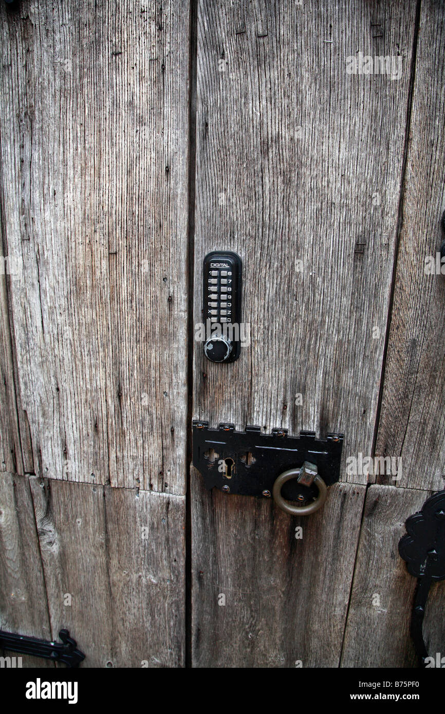 Old door with modern code lock Stock Photo - Alamy