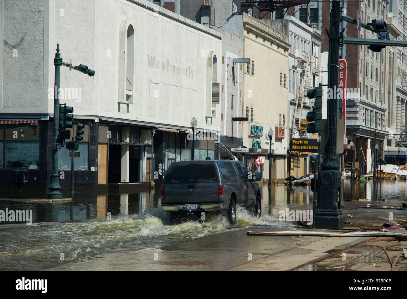 SUV splashes through flood water on canal st New Orleans after Hurricane Katrina Stock Photo - Alamy