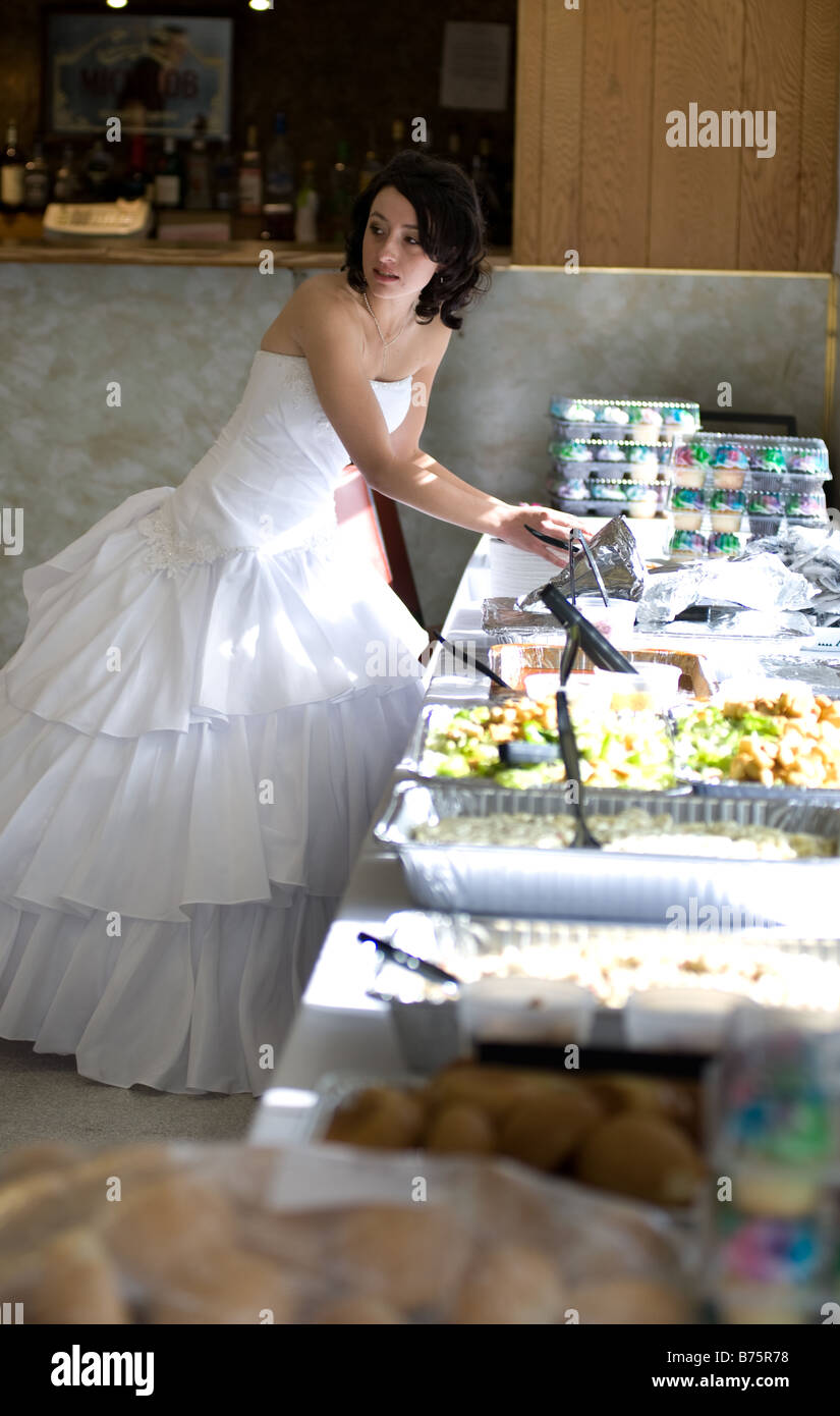 Bride getting food at wedding reception Stock Photo - Alamy
