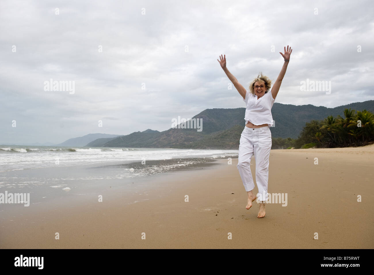 Lady dancing on the Beach Stock Photo - Alamy