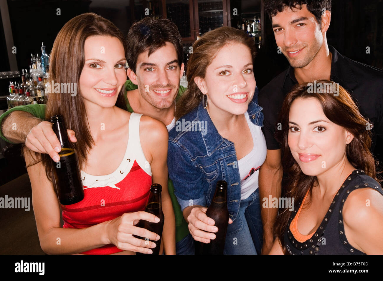 Portrait of five friends smiling at a bar counter Stock Photo - Alamy