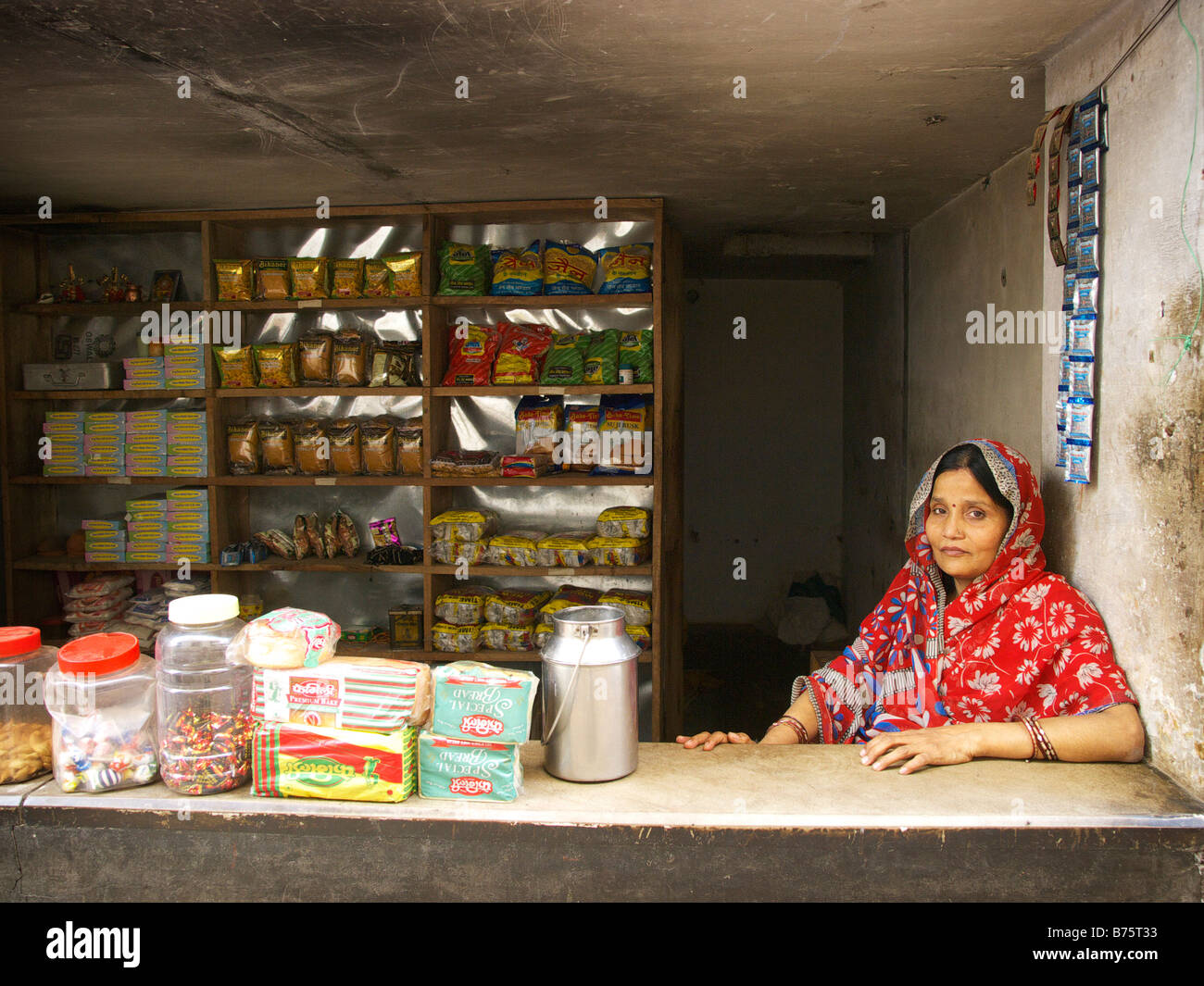 Indian lady sitting behind the counter of he shop in varanasi Stock ...