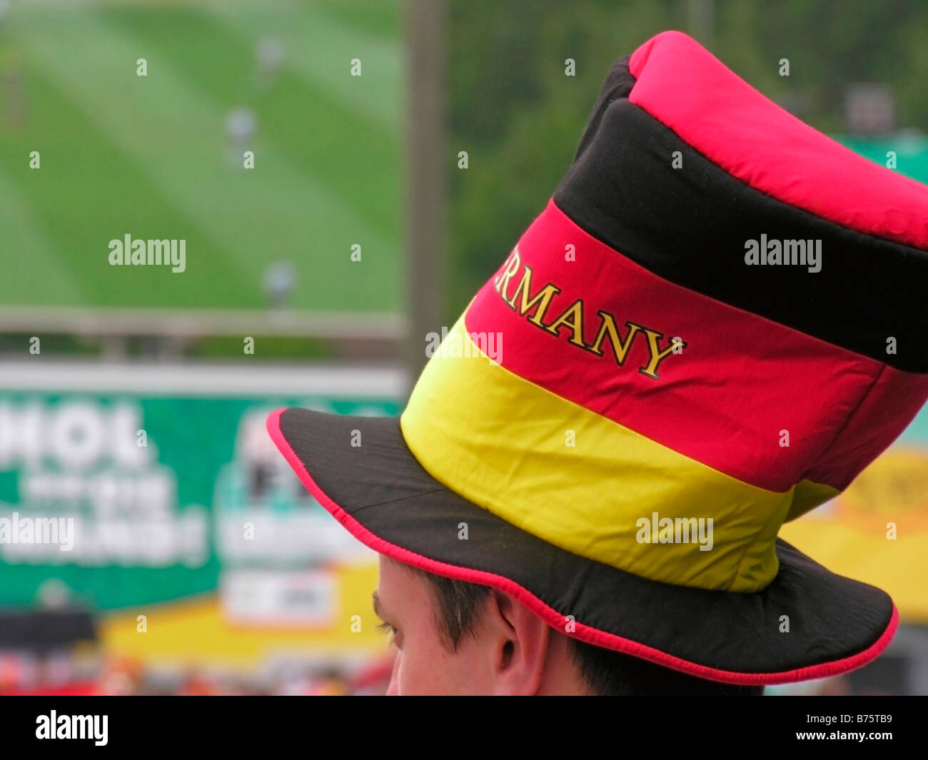 German football fan with a funny hat in german colours black red and ...