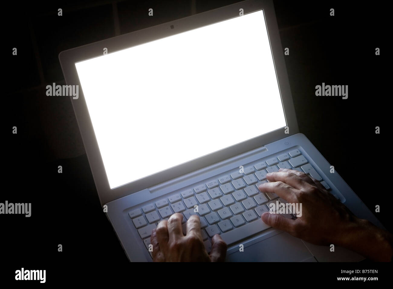 hands typing a letter in the keyboard of Stylish laptop computer with ...