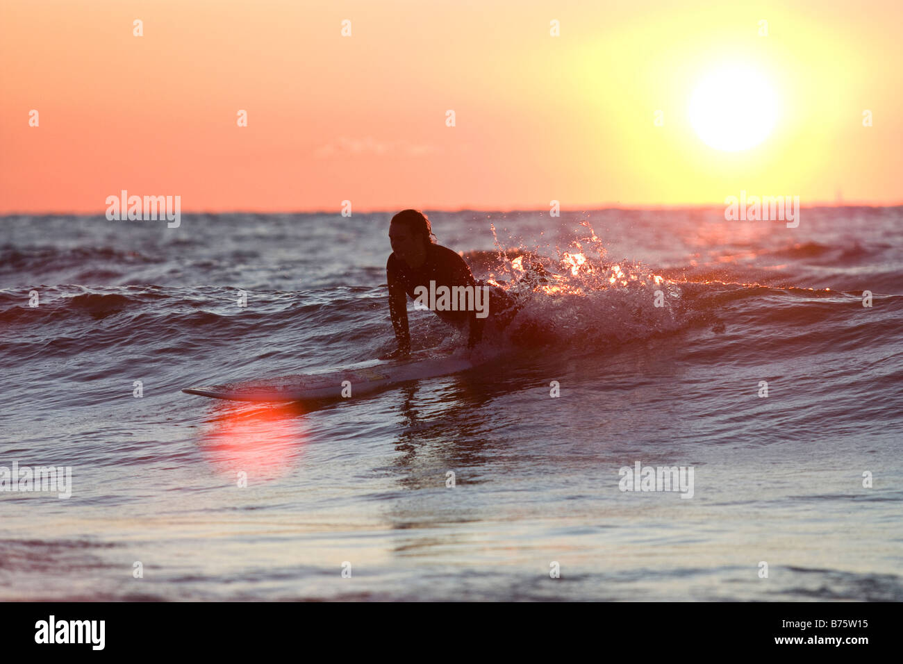 Surfer getting ready to catch a small wave on Lake Michigan Stock Photo ...