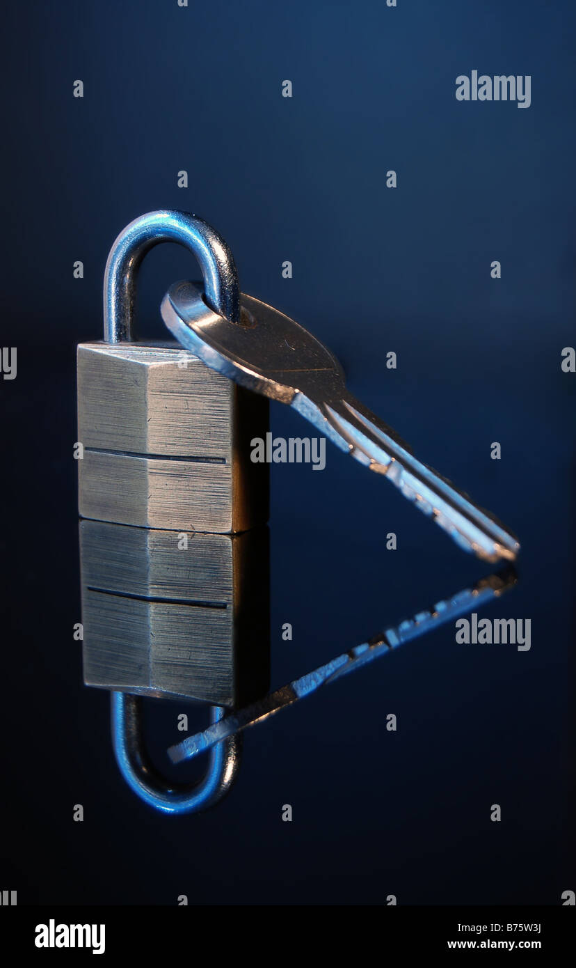 House key with lock on dark background Stock Photo - Alamy