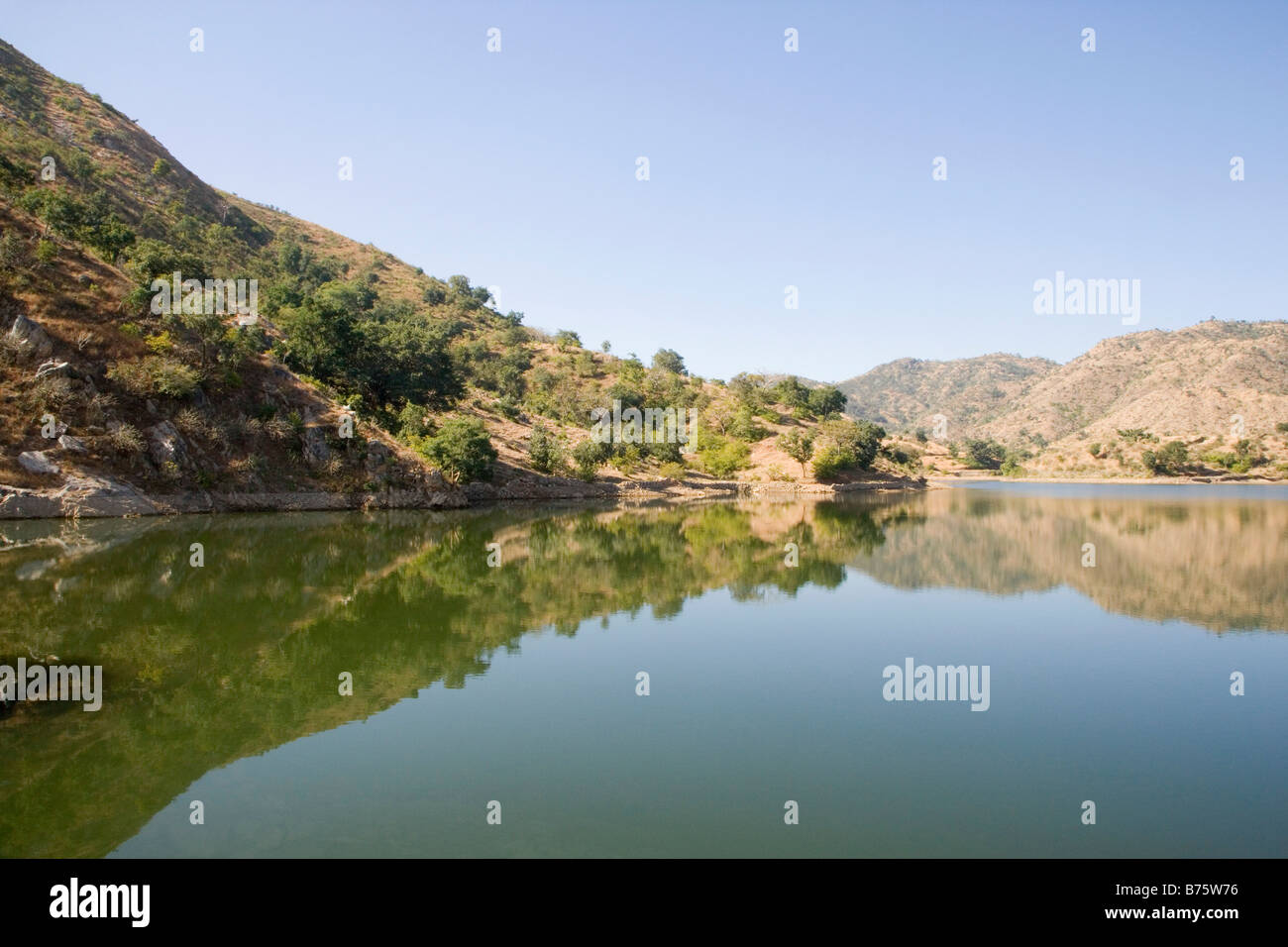 Reflection of mountain in a lake, Udaipur, Rajasthan, India Stock Photo ...