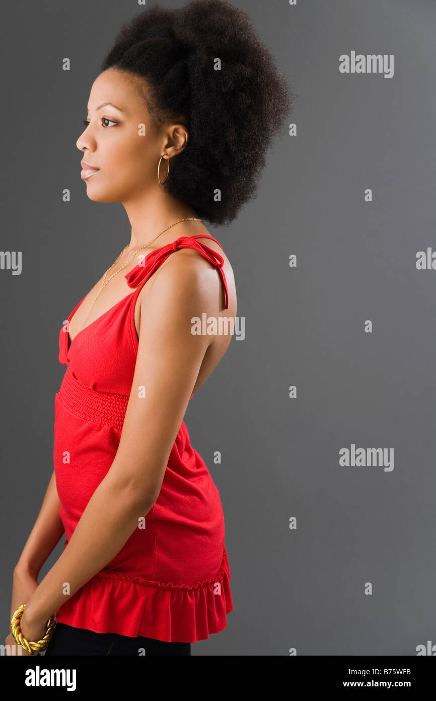 Side profile of a young woman standing and thinking Stock Photo - Alamy
