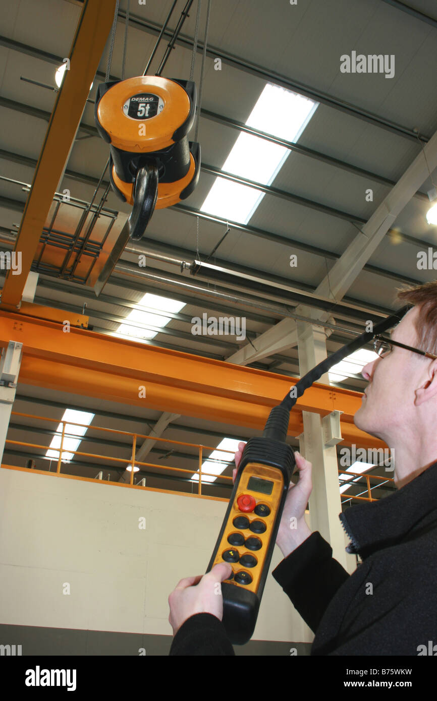 Man operating an overhead crane in a factory Stock Photo - Alamy