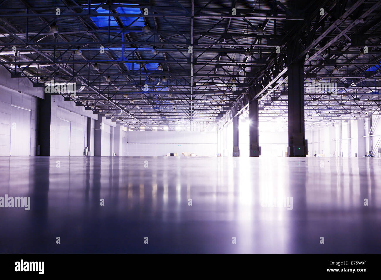 Modern empty storehouse with lights at far side Stock Photo - Alamy