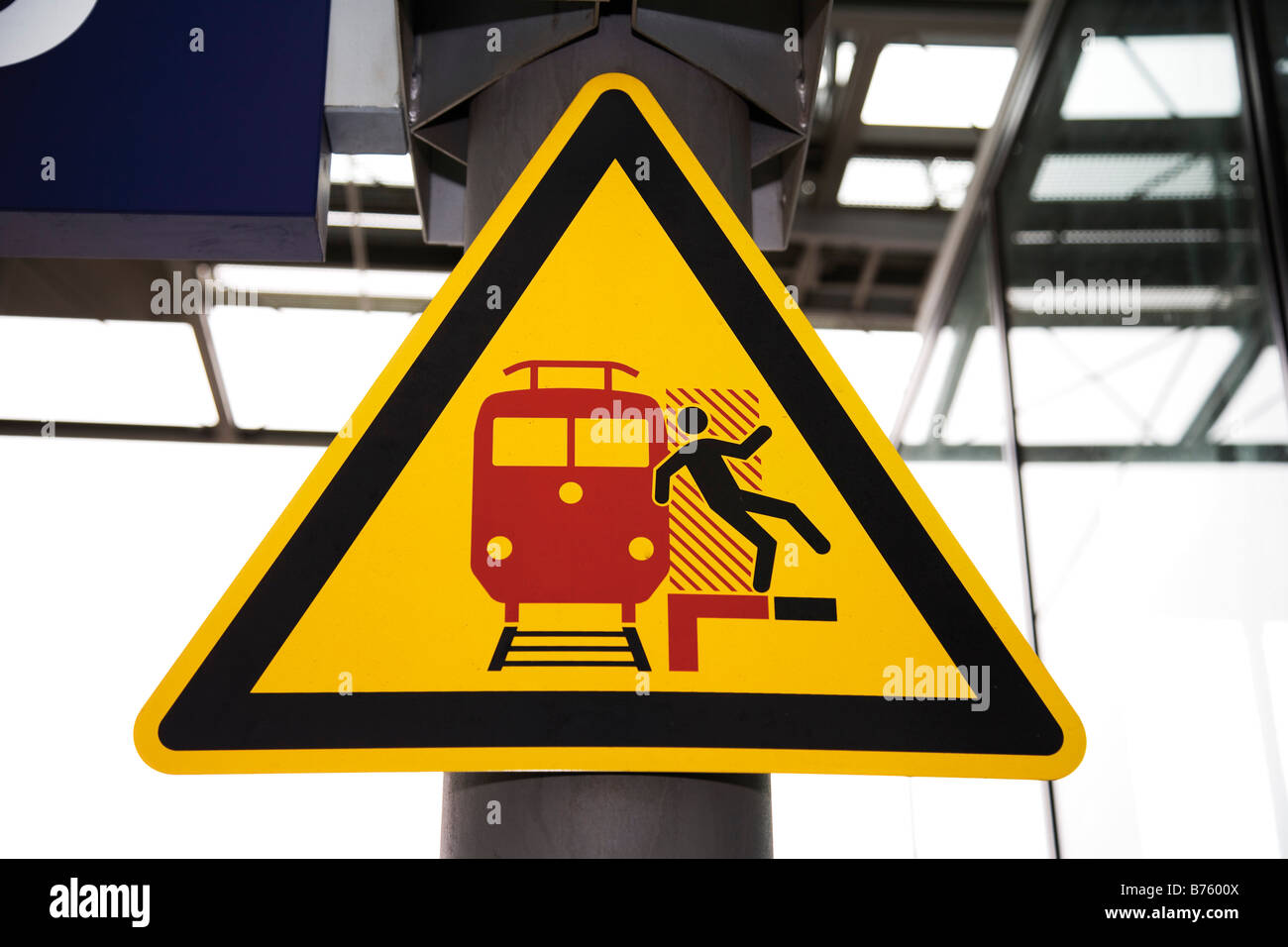 Warning sign at train station Stock Photo - Alamy
