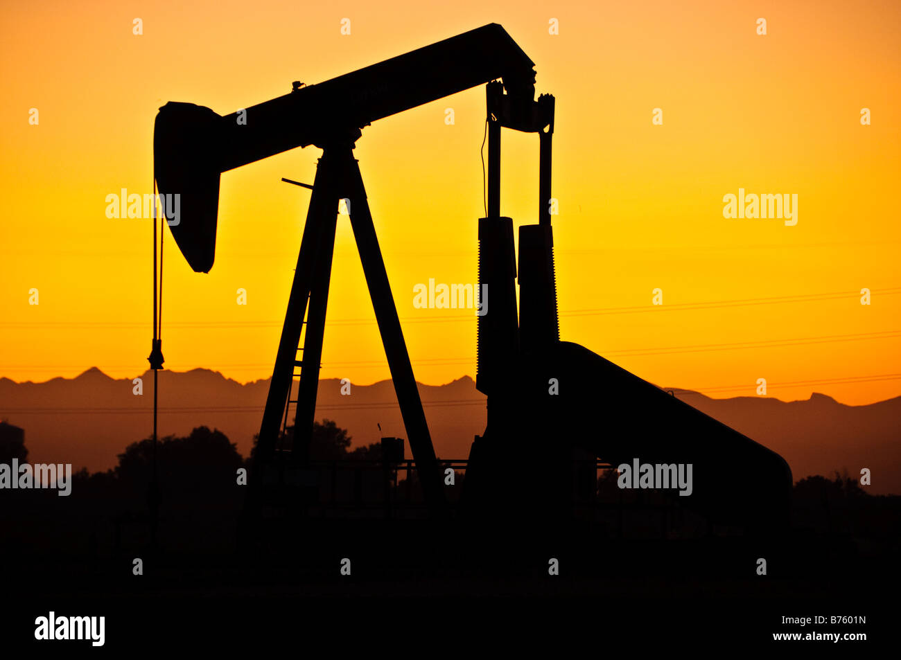 OIl well at sunset Stock Photo - Alamy