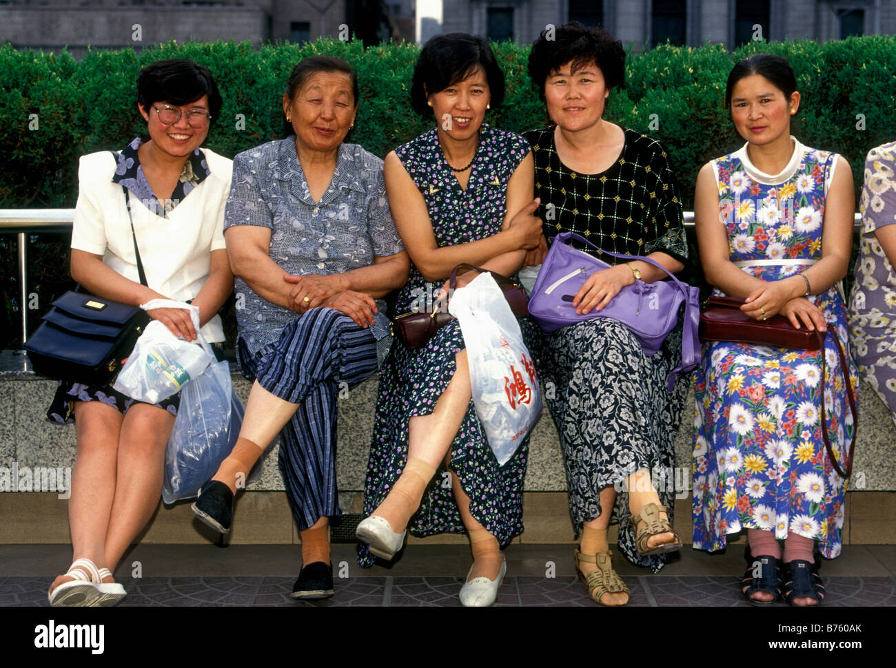 Chinese women sitting on bench along The Bund Waitan Shanghai Shanghai ...