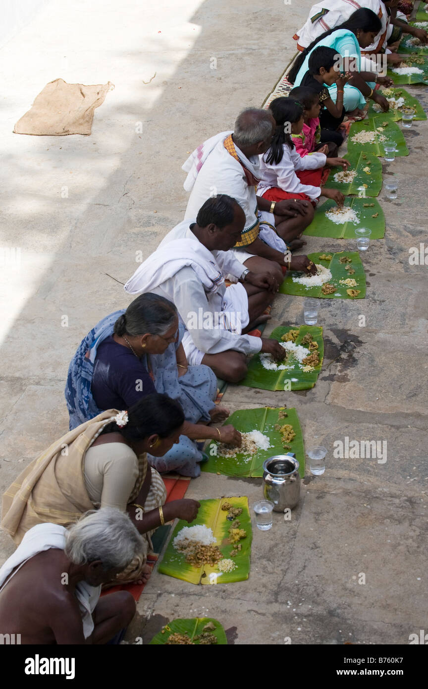 Feeding Indian men, women and children at a hindu temple in India Stock ...