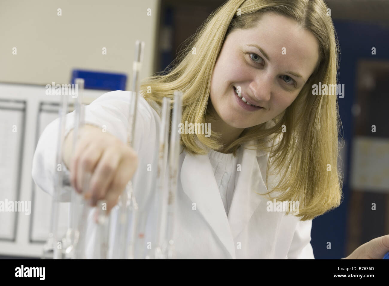 Female scientist removing volumetric pipette from a pipette rack Stock ...