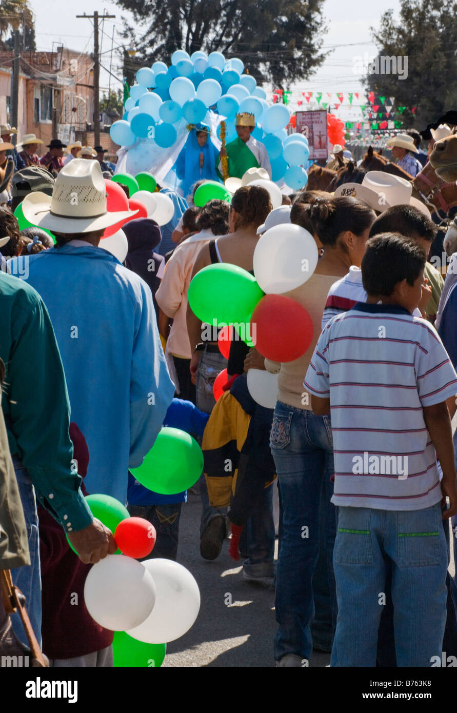 A crowd follows religious figures at the festival of the VIRGIN OF ...