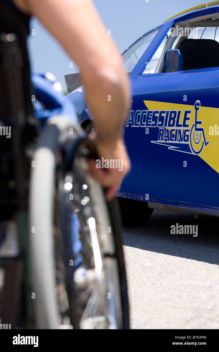 Person on wheelchair approaching to racing car, close-up Stock Photo ...