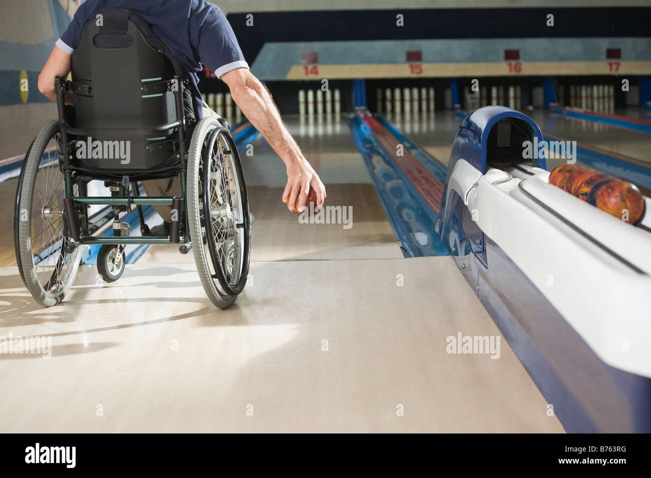 Rear view of a disabled man playing ten pin bowling Stock Photo - Alamy