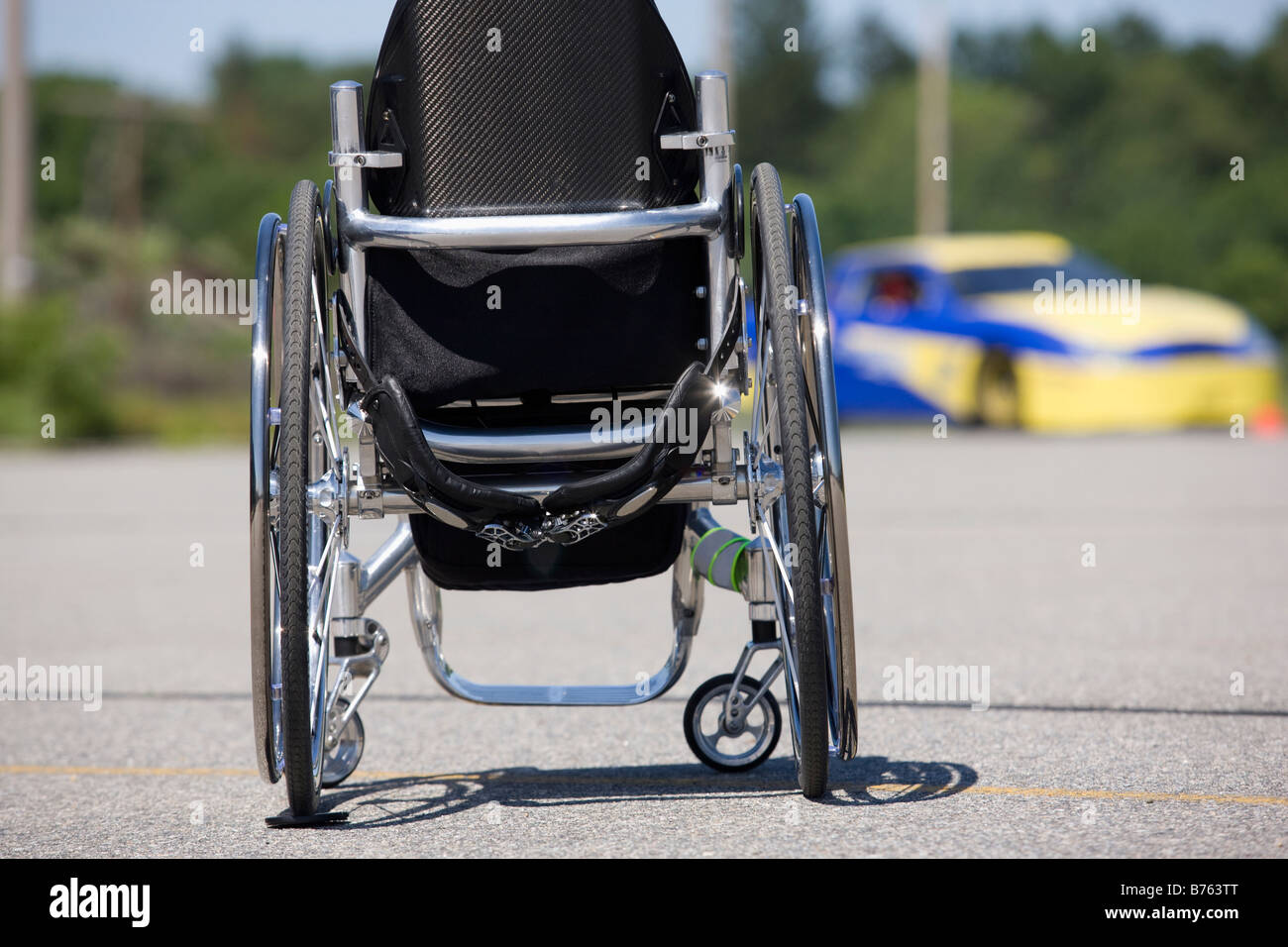 Wheelchair and race car in background Stock Photo - Alamy
