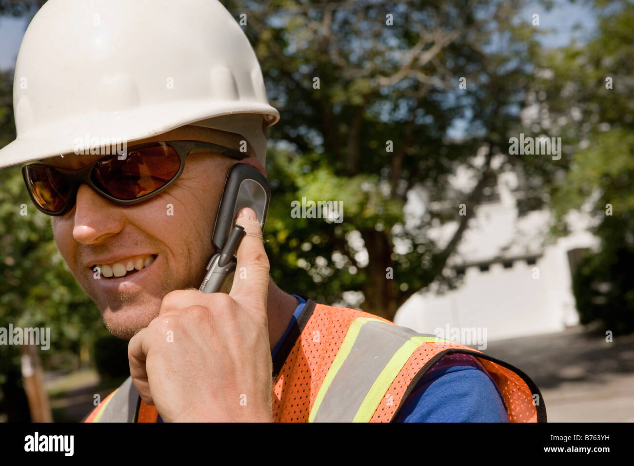 Construction worker talking on mobile phone Stock Photo - Alamy