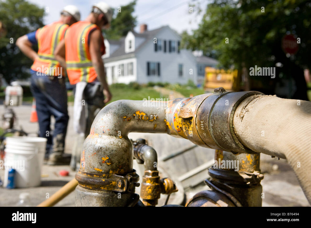 Water pump on construction site, two workers in background Stock Photo ...