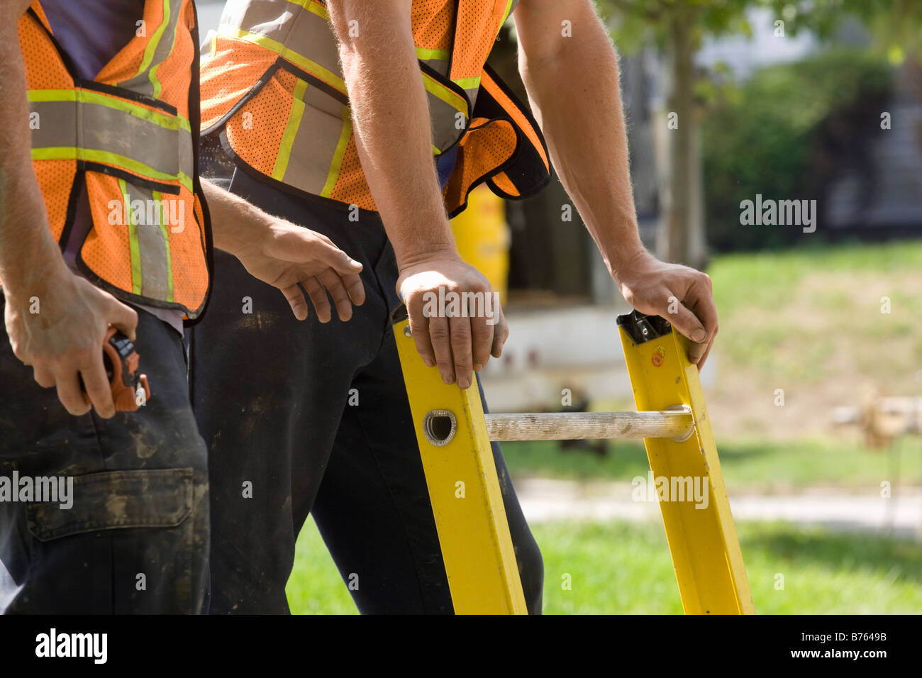 Two workers on construction site, mid section Stock Photo - Alamy