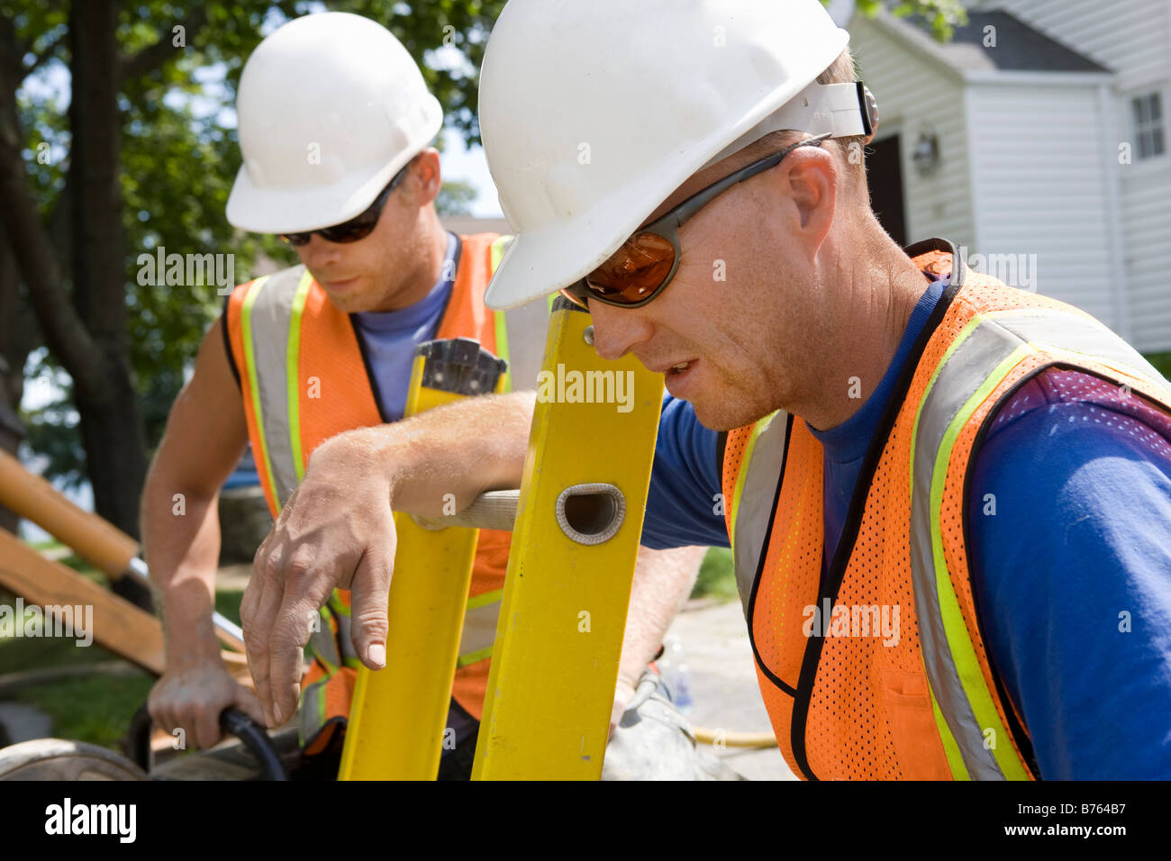 Two workers talking on construction site Stock Photo - Alamy