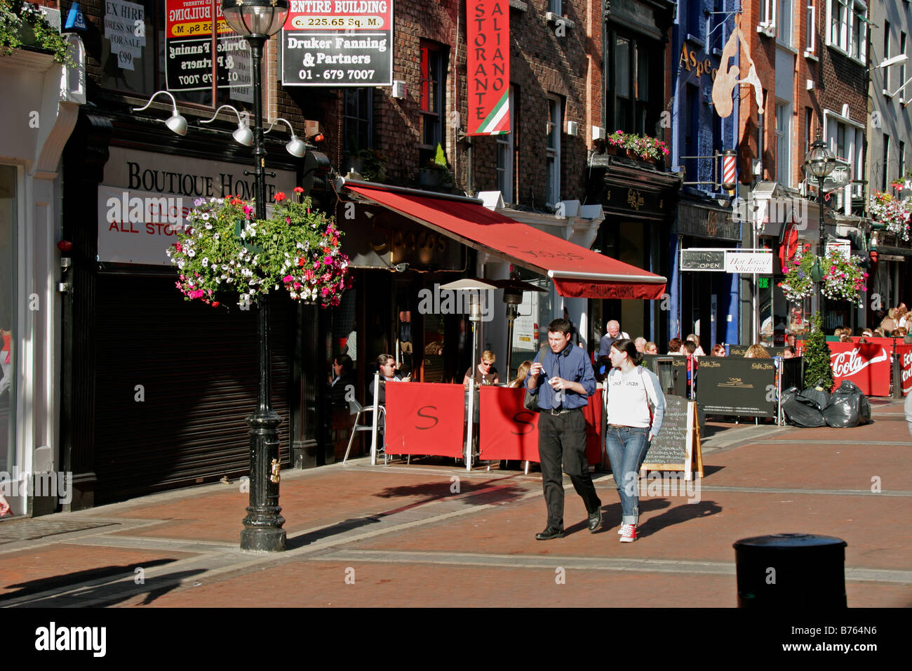View of a busy Dublin street during summer with people and restaurants ...