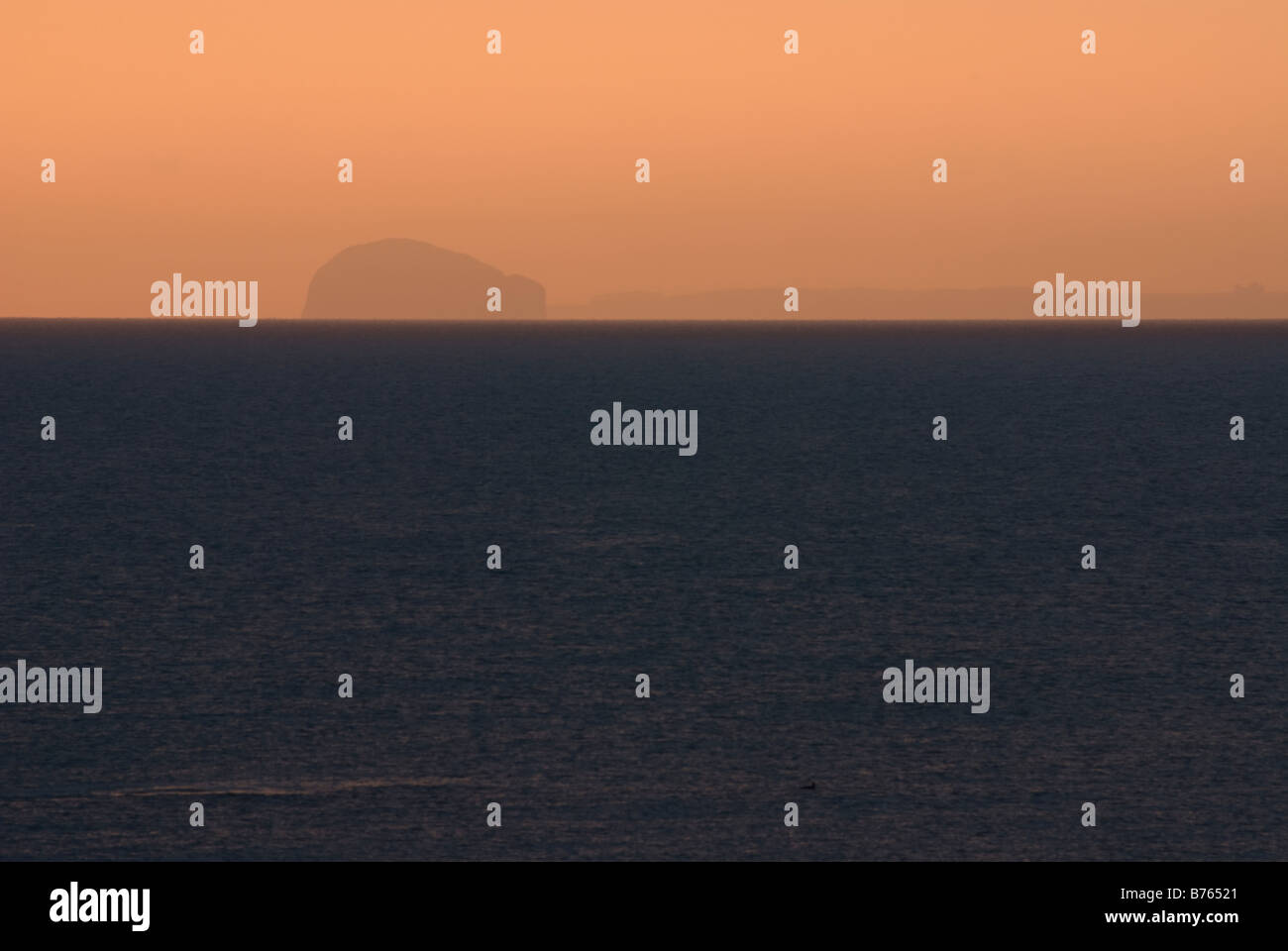 Sunrise behind Bass Rock an island bird sanctuary in the Firth of Forth ...