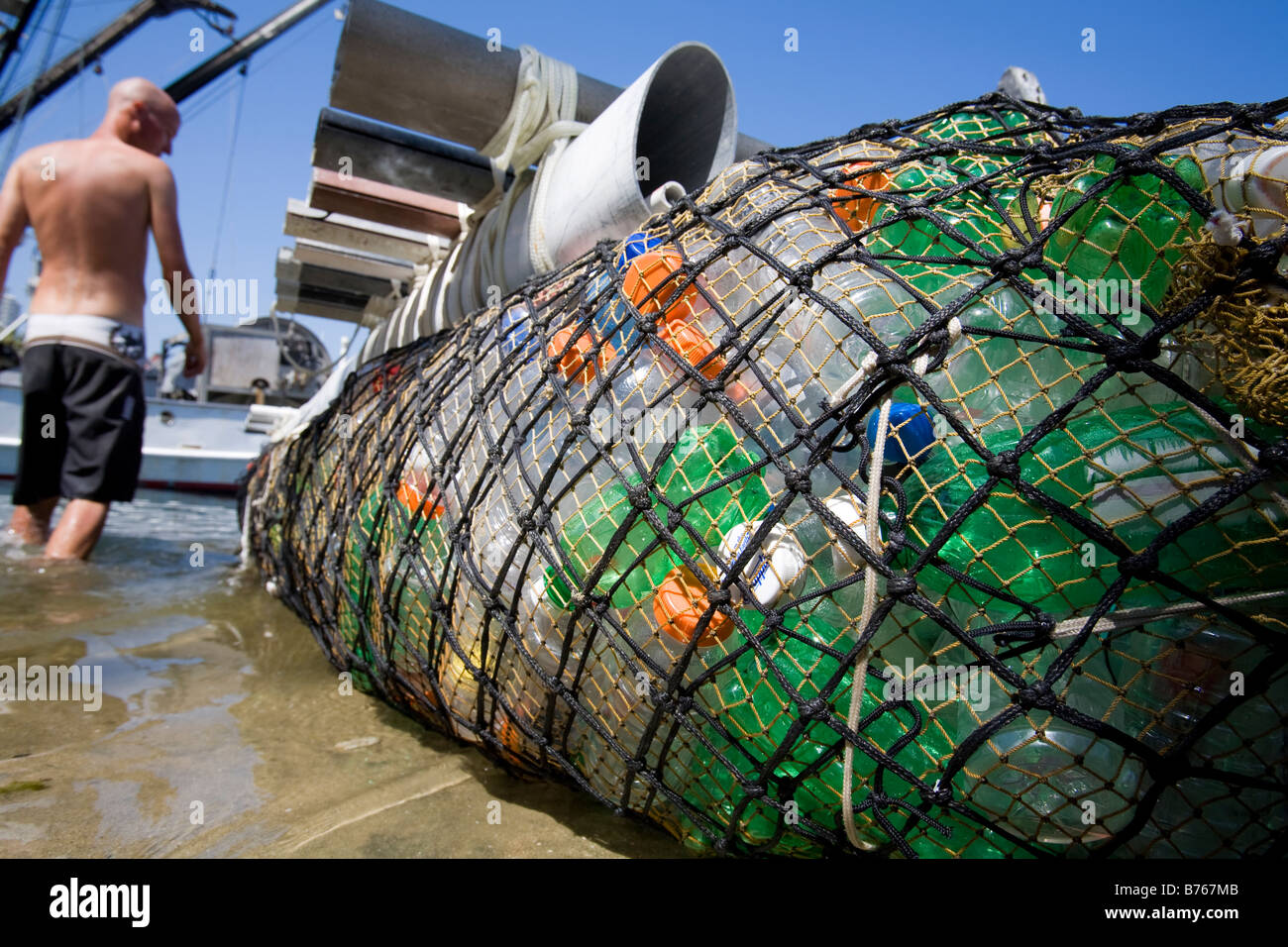 Algalita's Joel Paschal checks the Junk raft after it's initial test ...