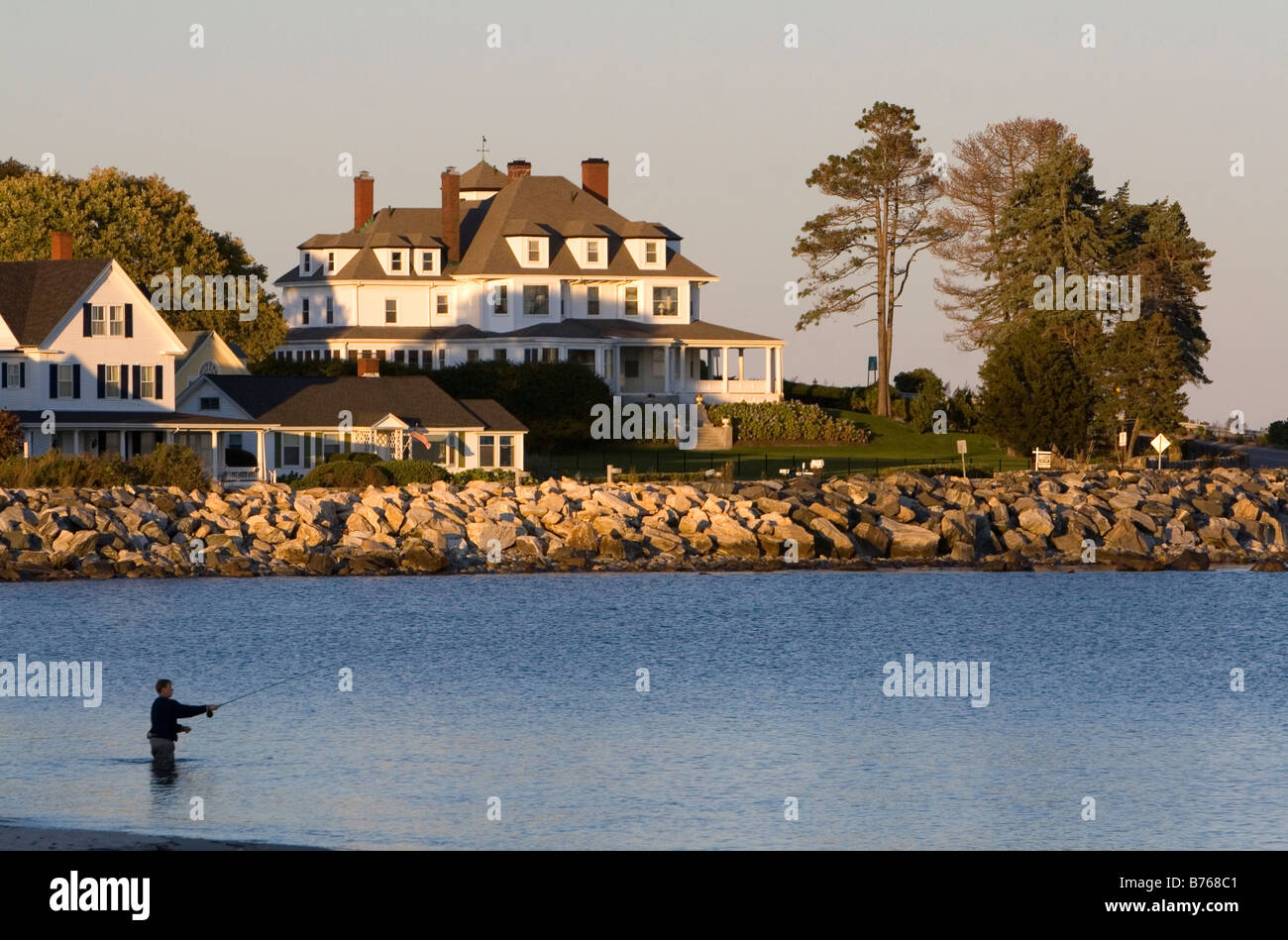 Waterfront home and man fishing at the village of Hampton Beach New ...