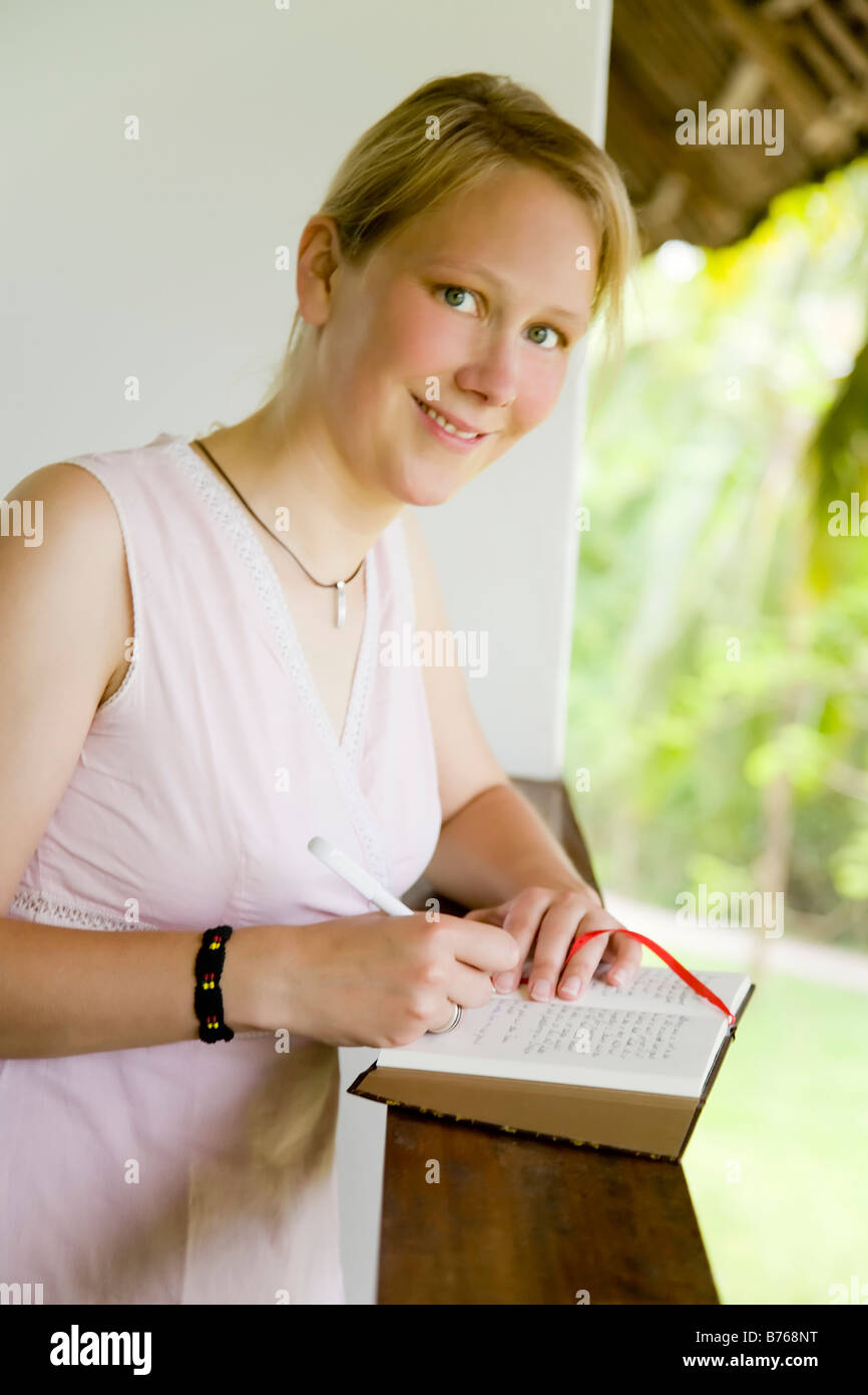 young blond girl writing Stock Photo - Alamy