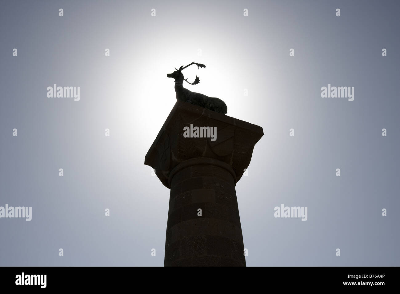Silhouette of bronze statue at the entrance to Mandraki harbour Rodos ...