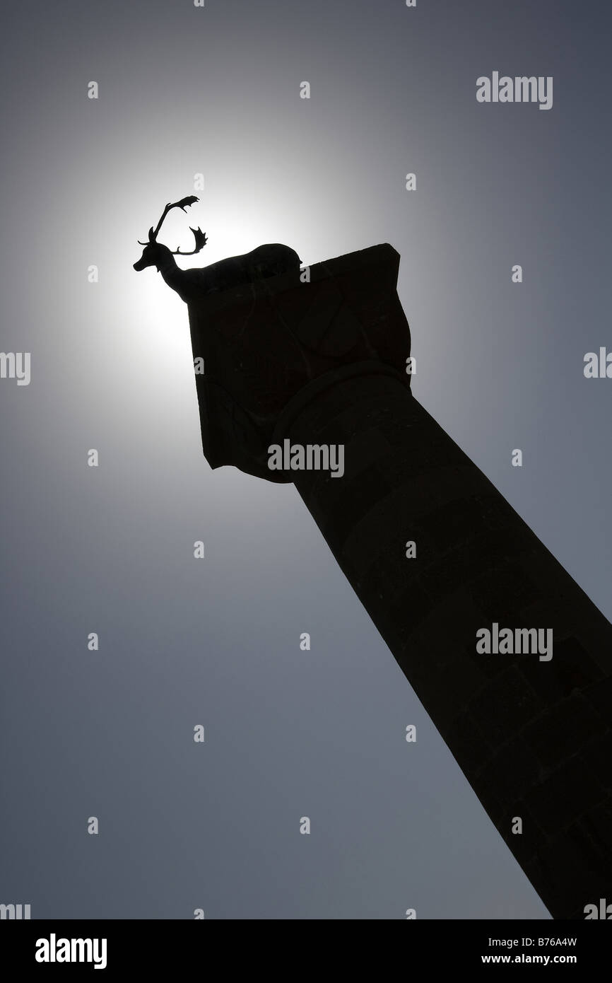 Silhouette of bronze statue at the entrance to Mandraki harbour Rodos ...