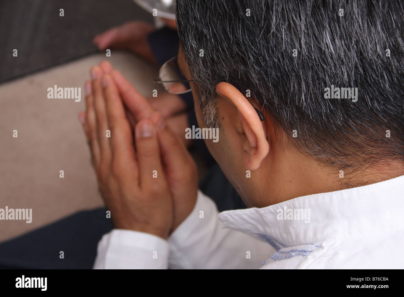 An Asian man praying Stock Photo - Alamy