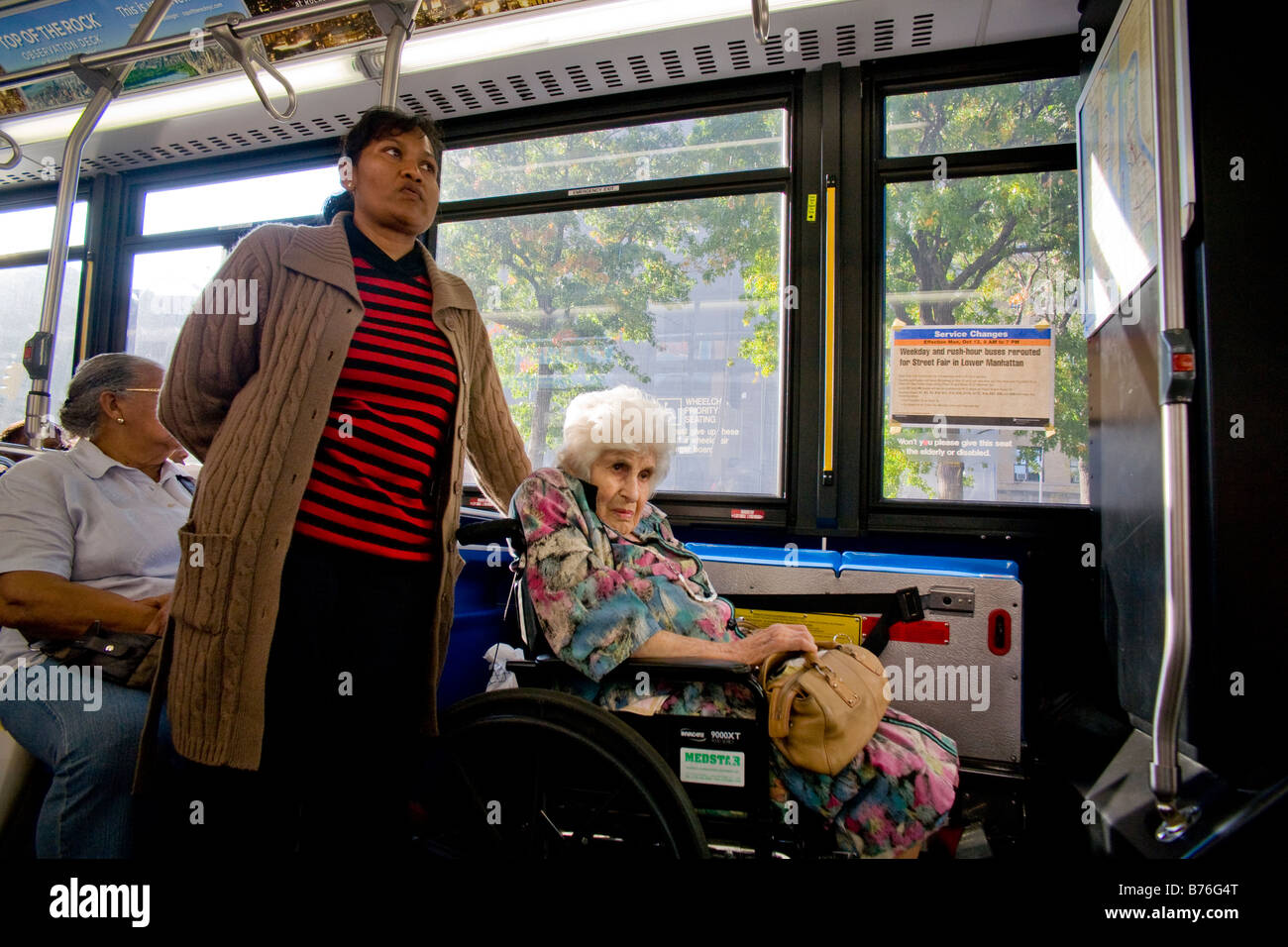 Wheelchair bound elderly woman and her health-care worker travelling in ... Wheelchair bound elderly woman and her health-care worker travelling in ...