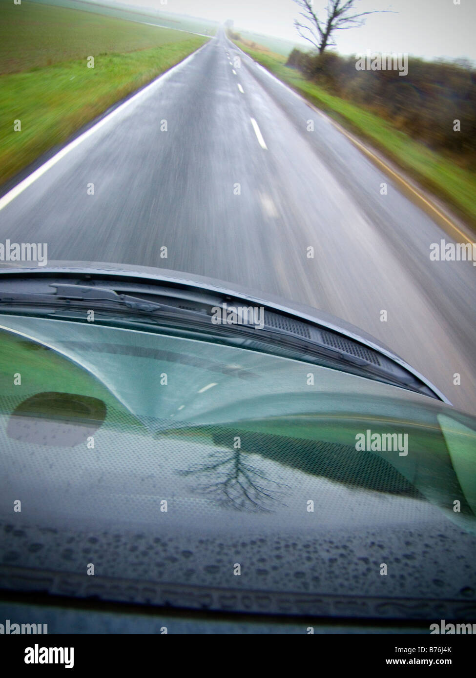 A car driving at speed on an open country road Stock Photo - Alamy