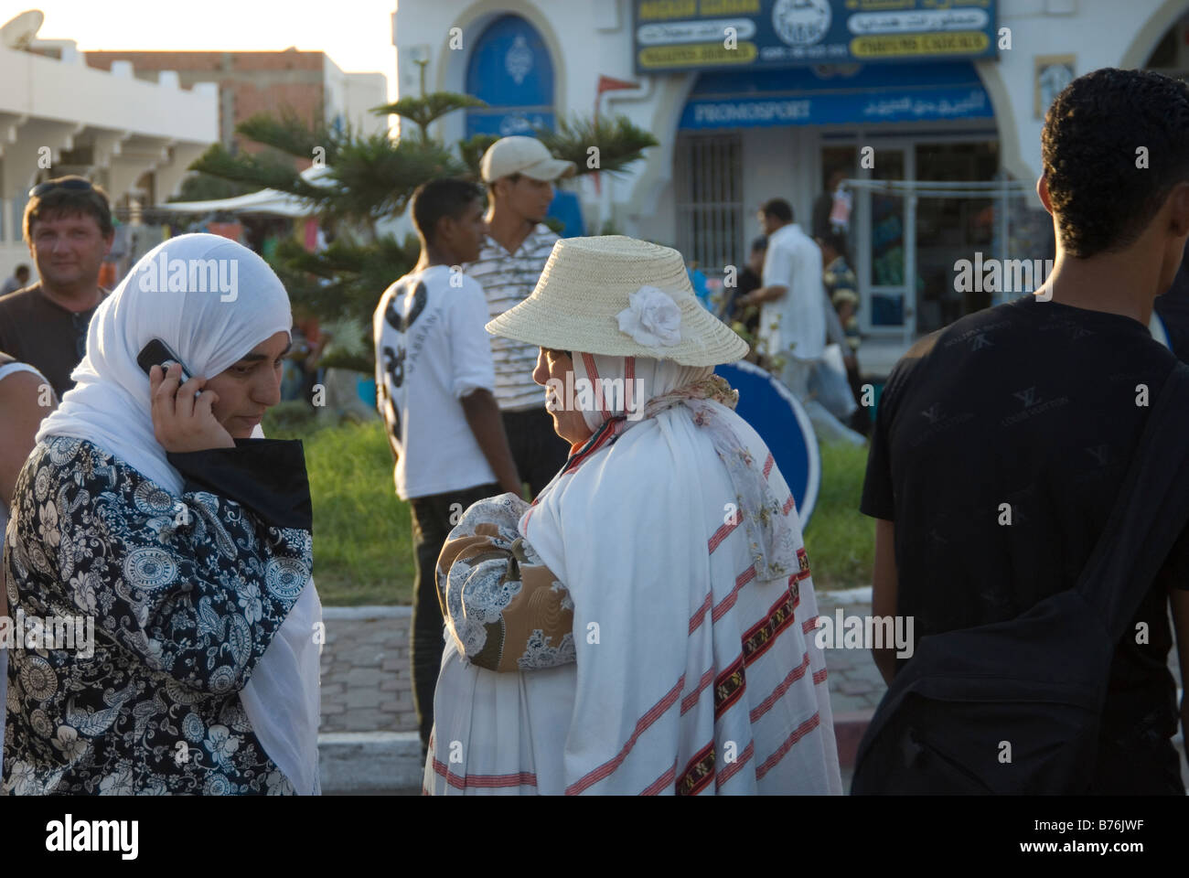 women in djerba using cellular phone Stock Photo - Alamy