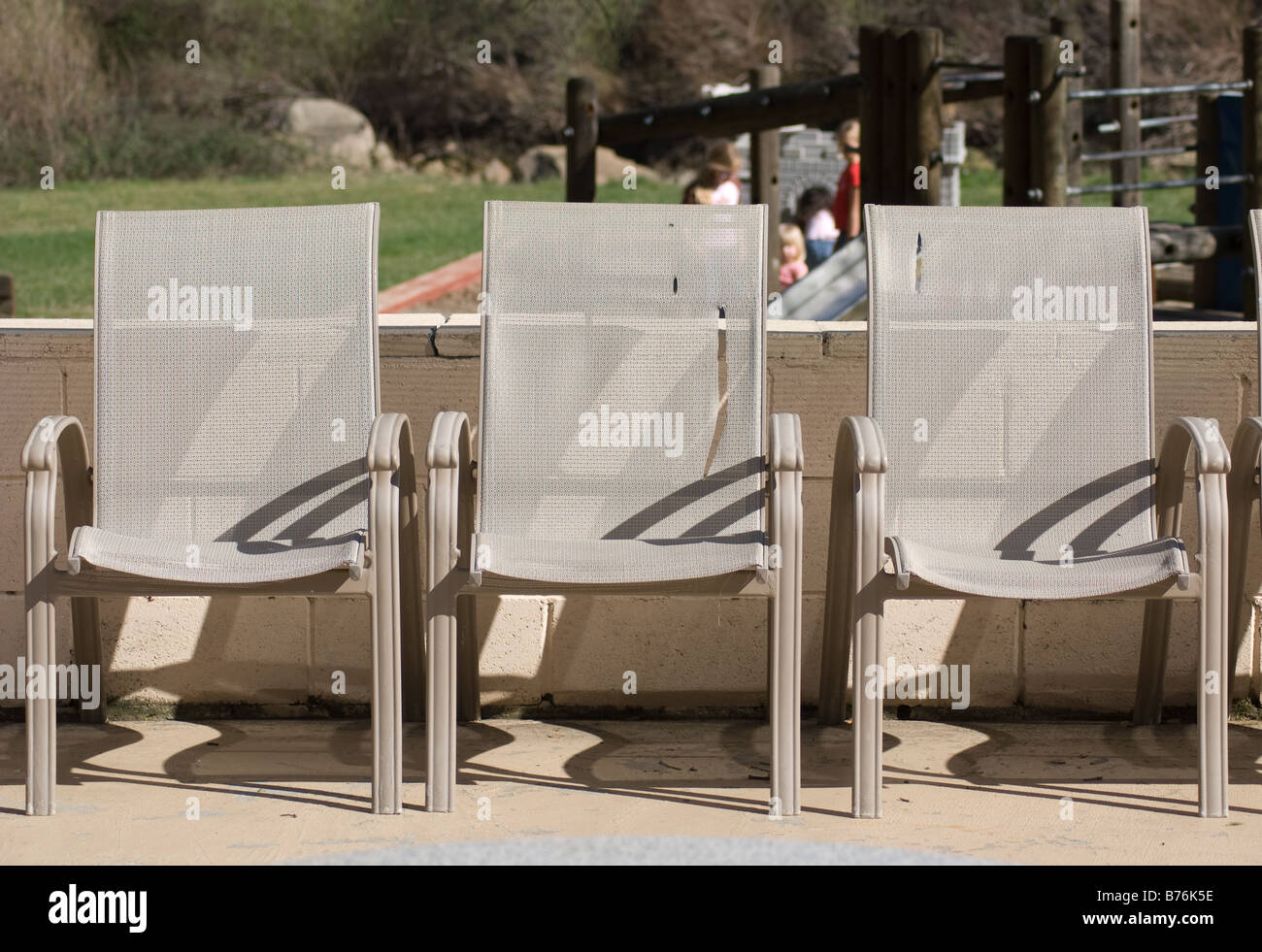 3 Chairs on patio with torn fabric Stock Photo - Alamy