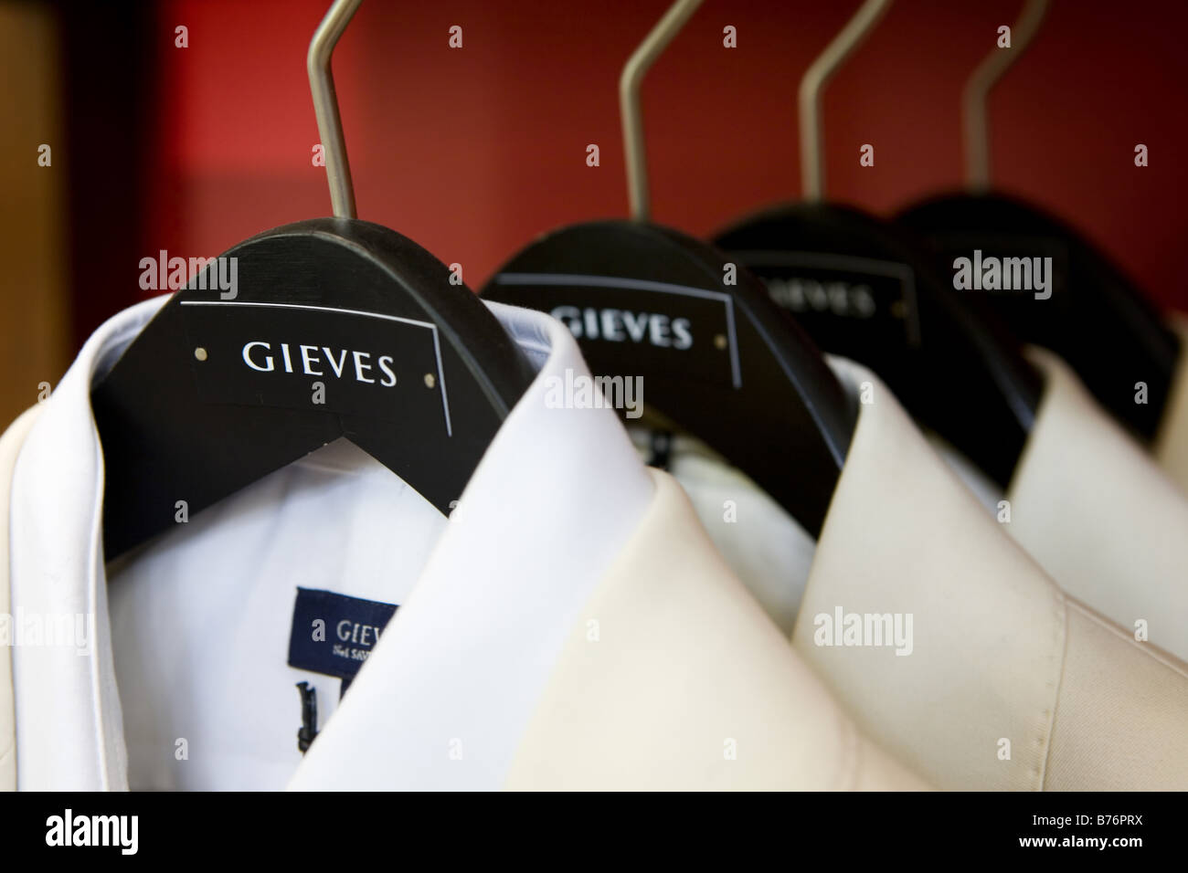 Gieves & Hawkes men's tailors displaying suits on hangers in their ...