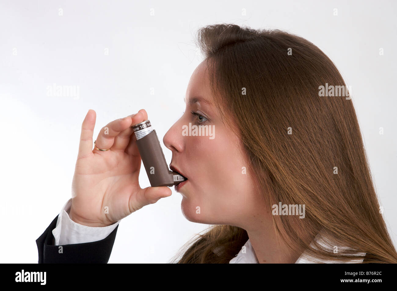 Young woman using inhaler Stock Photo - Alamy