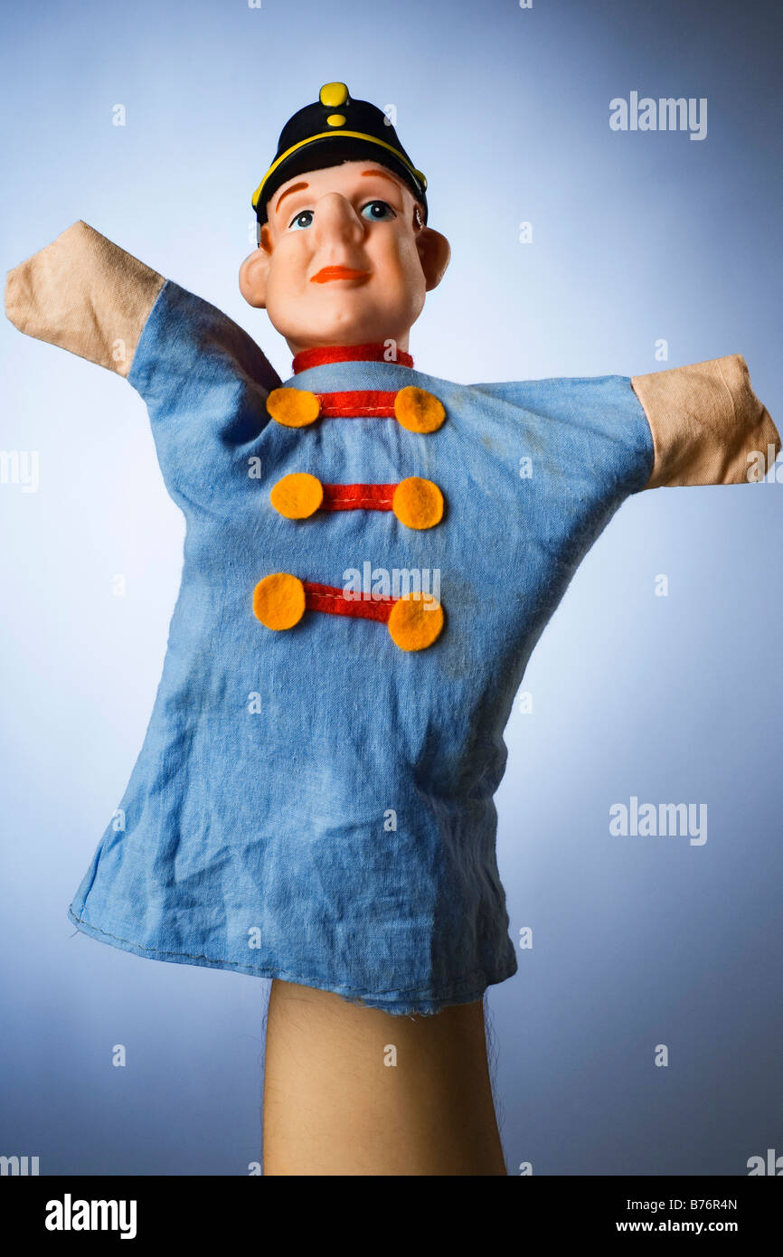 toy hand puppet against blue background Stock Photo - Alamy