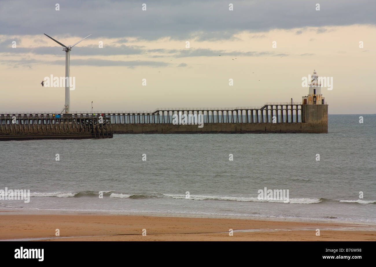 Blyth pier with sea fishermen and wind turbine Stock Photo - Alamy