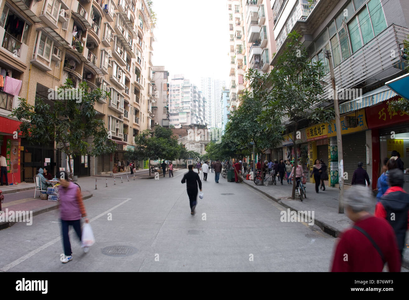 A busy urban side moder residential street bustling with the early ...