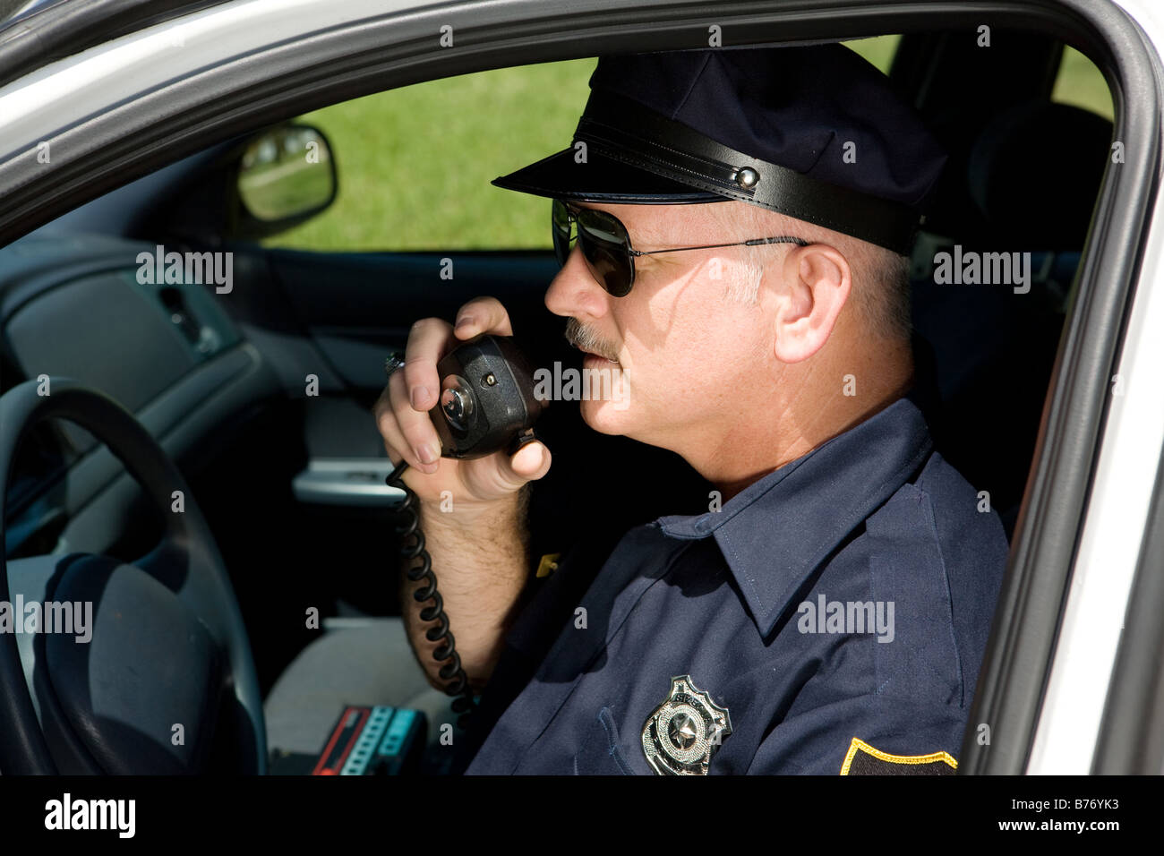 Police officer in squad car talking on his radio Closeup view Stock ...