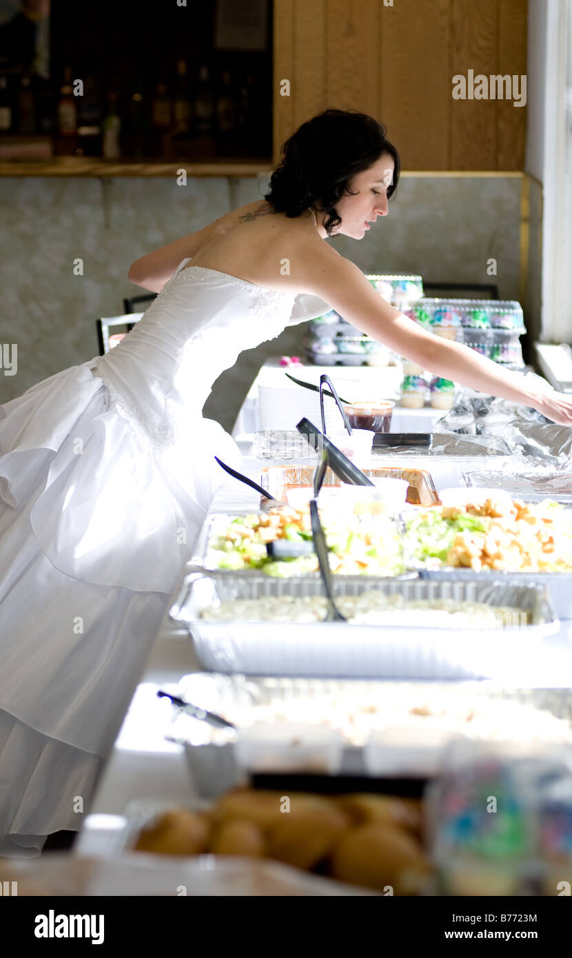Bride getting food at wedding reception Stock Photo - Alamy